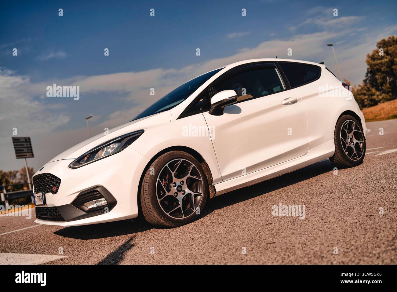 Rome, italy 10 september 2025: white ford fiesta st parked on sunlit ...