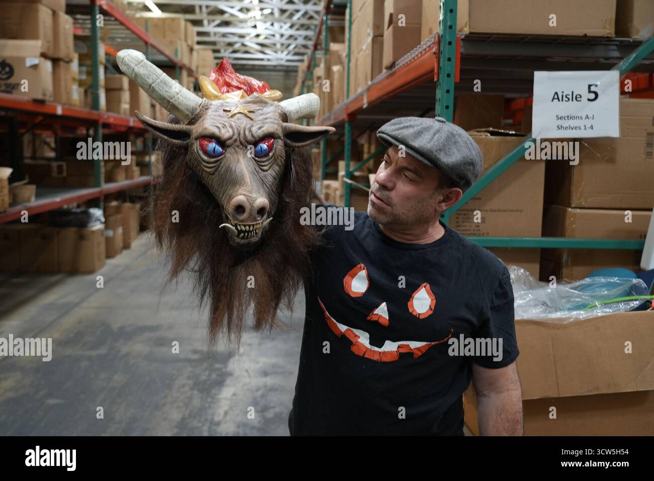Chris Zephro, co-owner of Trick or Treat Studios, shows a mask inside a ...