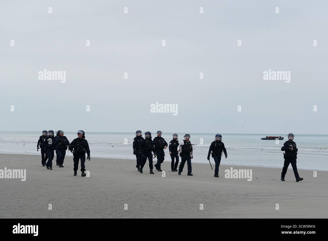 French authorities on the beach in Gravelines, France, as a small boat ...