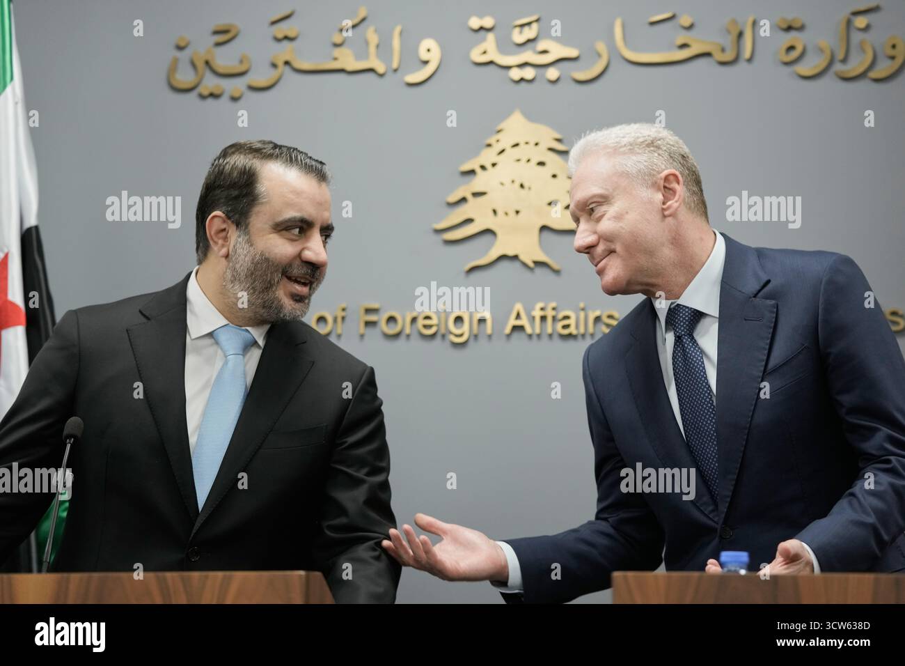 Syrian Foreign Minister Asaad al-Shibani, left, speaks with Lebanese ...