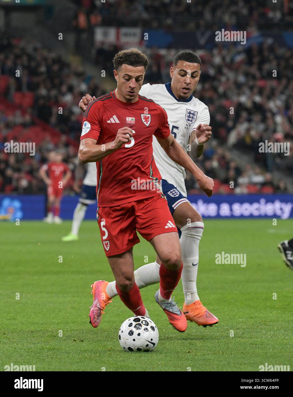 Ethan Ampadu of Wales and Morgan Rogers of England in action during the ...