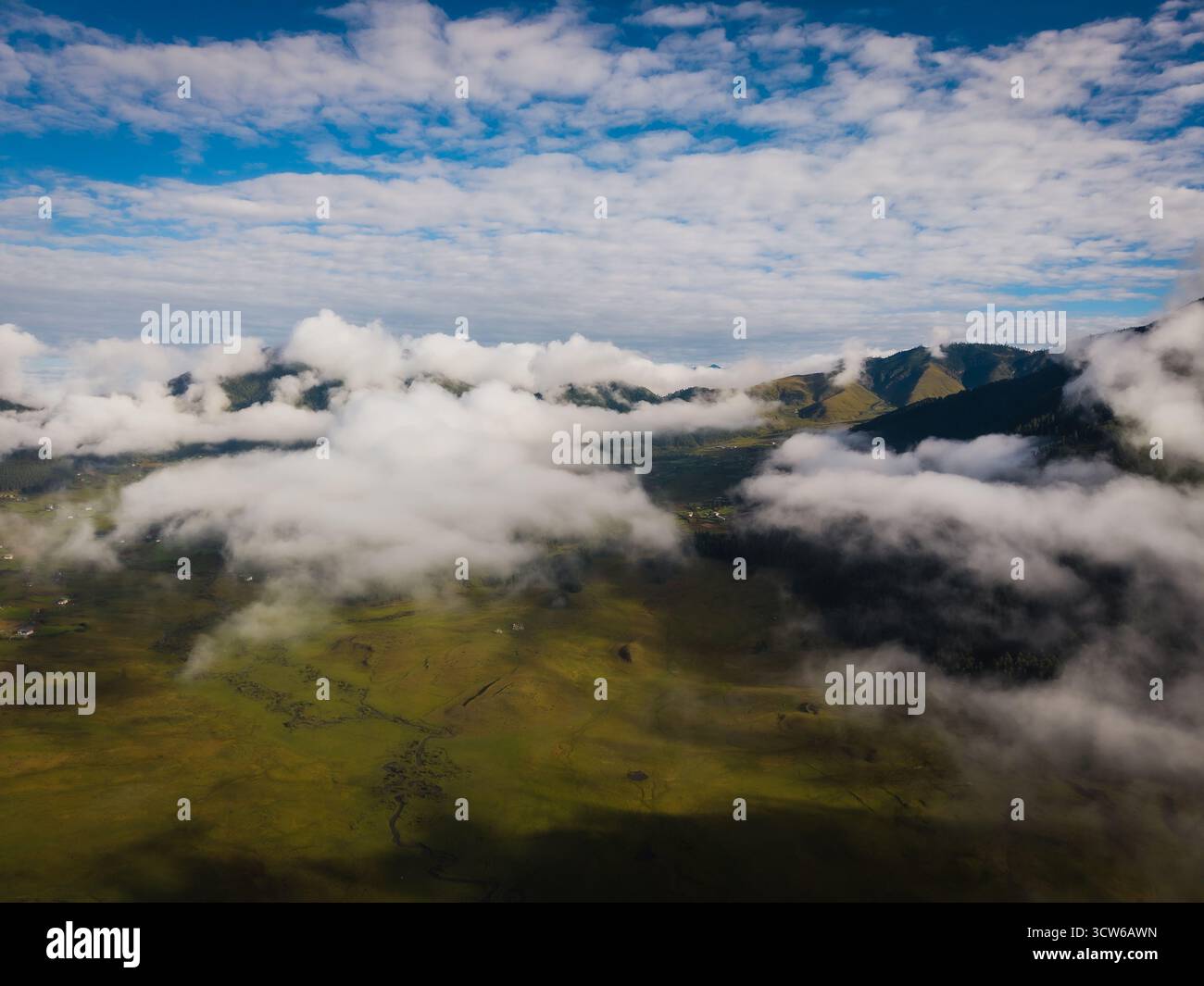 Aerial view of the Phobjikha Valley floor peeks through a sea of ...