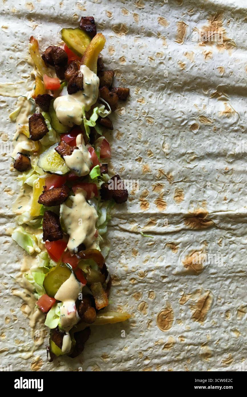 Traditional shawarma wrap with grilled meat, fresh vegetables, and ...