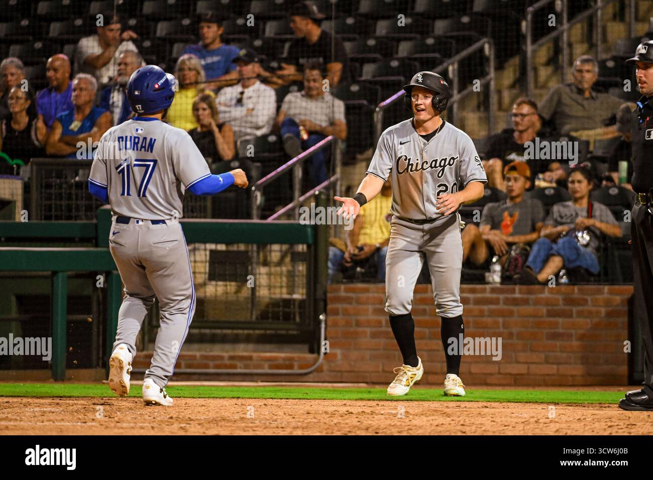 Glendale Desert Dogs catcher Edward Duran (17) celebrates with right ...