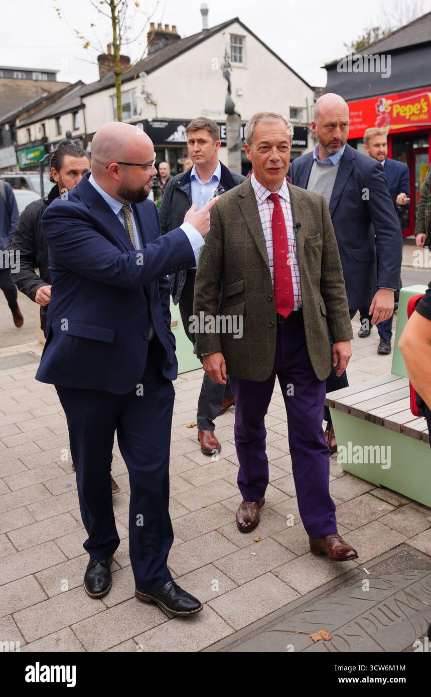 Reform UK leader Nigel Farage (right) campaigning in Caerphilly, South ...