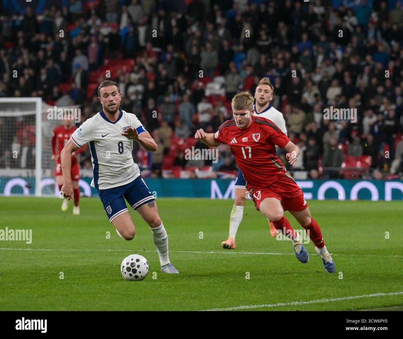 Jordon Henderson of England and Jordon James of Wales in action during ...