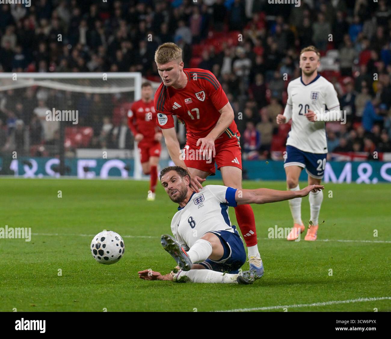 Jordon Henderson of England and Jordon James of Wales in action during ...