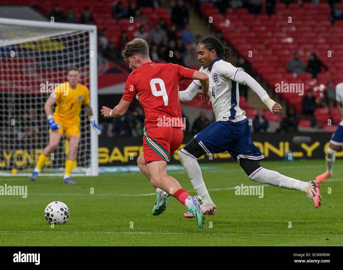 Djed Spence of England and Lewis Koumas of Wales in action during the ...