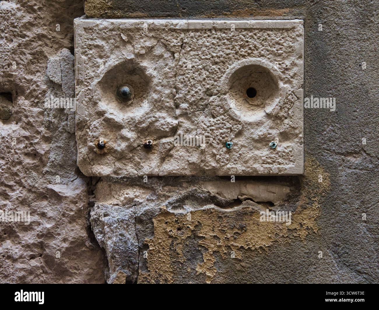 Ancient Worn Stone Plaque on Venetian Wall - Close-up of a textured ...