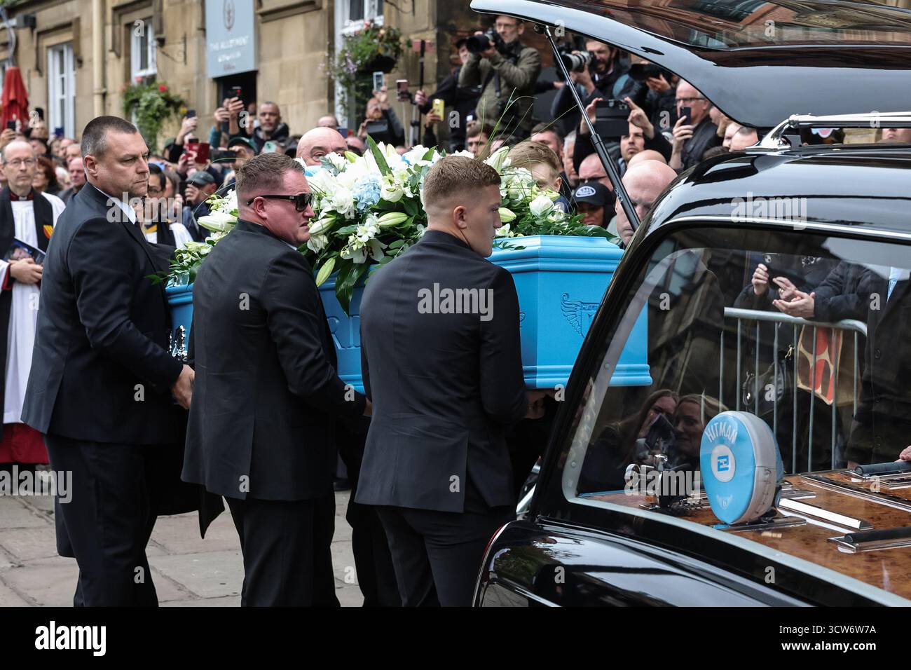 Richard John Hatton MBE’s coffin is placed in the hearse by family ...