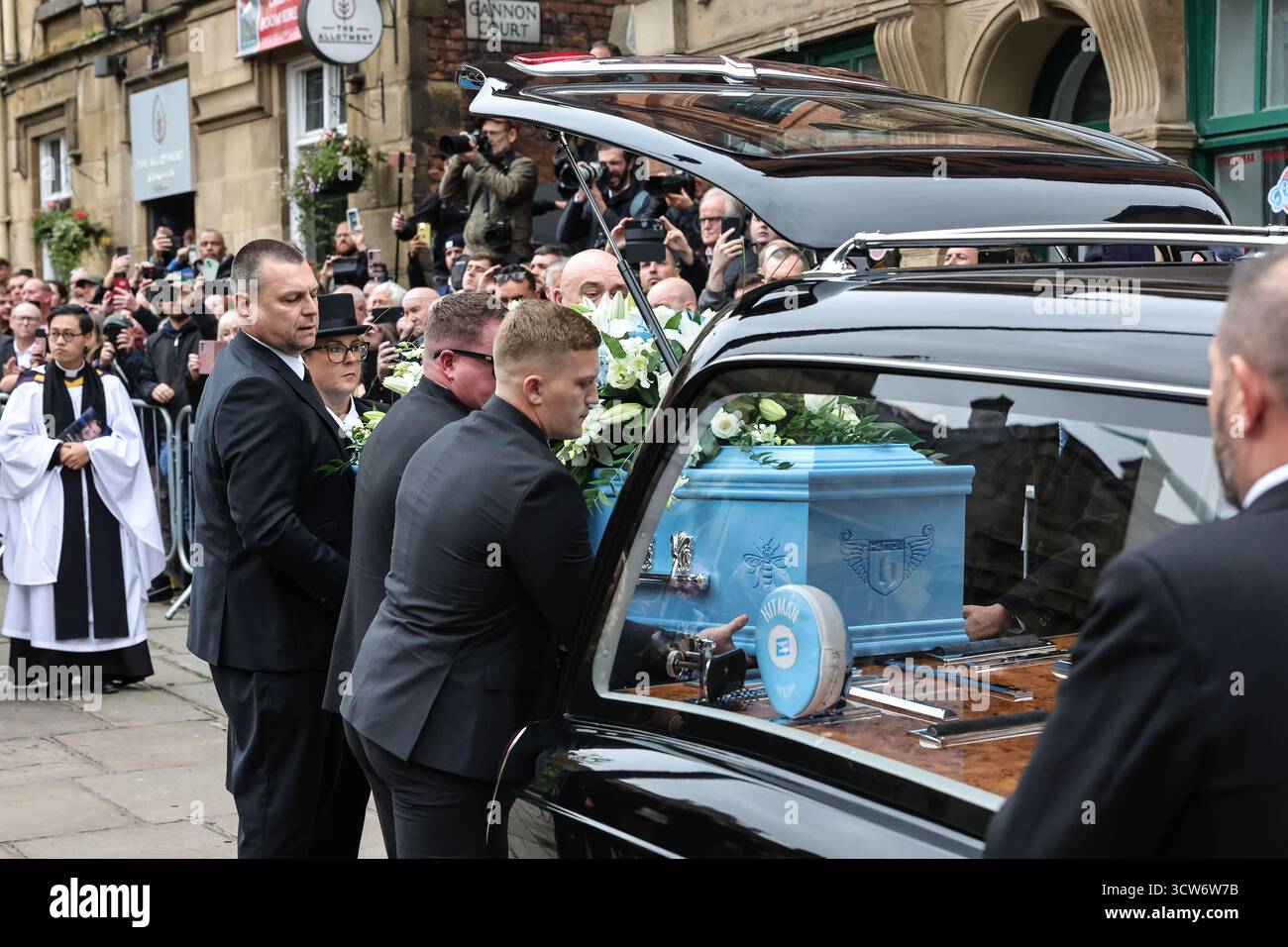 Richard John Hatton MBE’s coffin is placed in the hearse by family ...