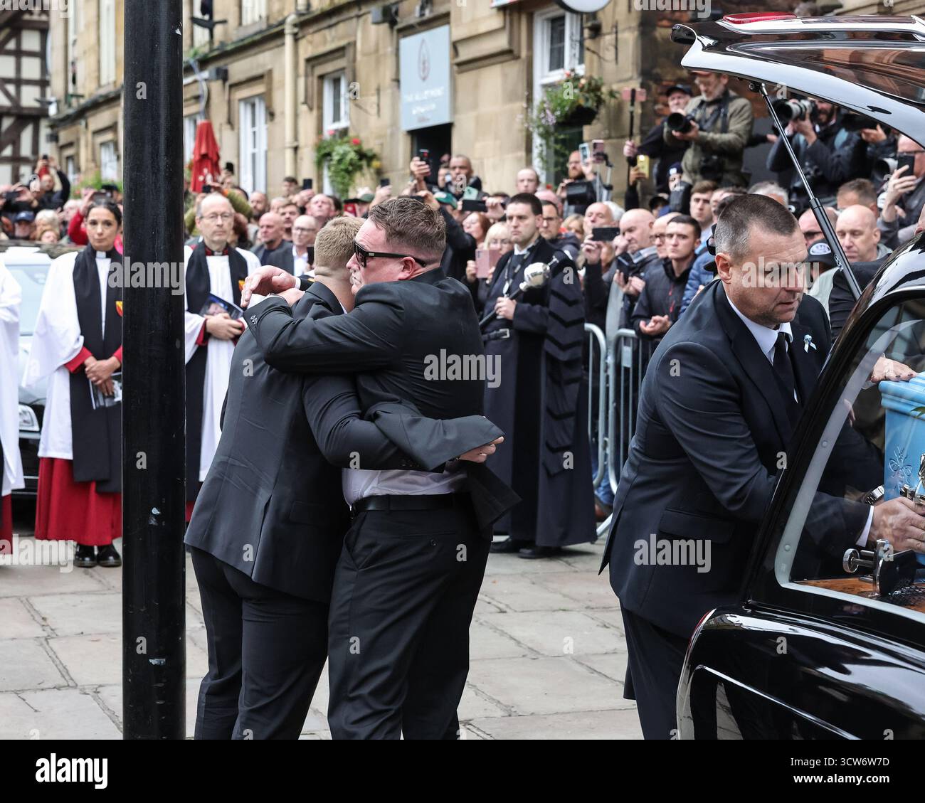 Richard John Hatton MBE’s coffin is placed in the hearse by family ...
