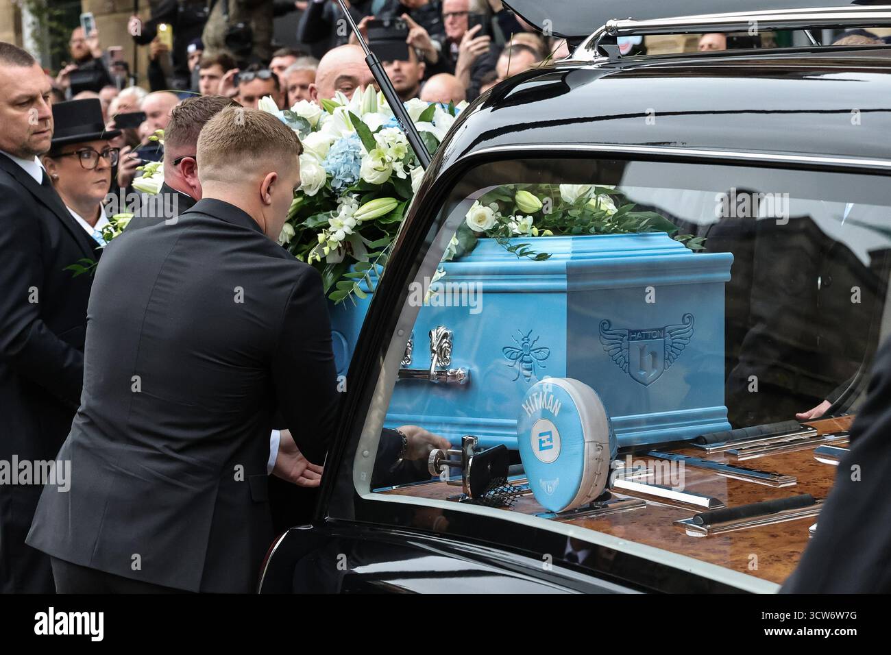 Richard John Hatton MBE’s coffin is placed in the hearse by family ...