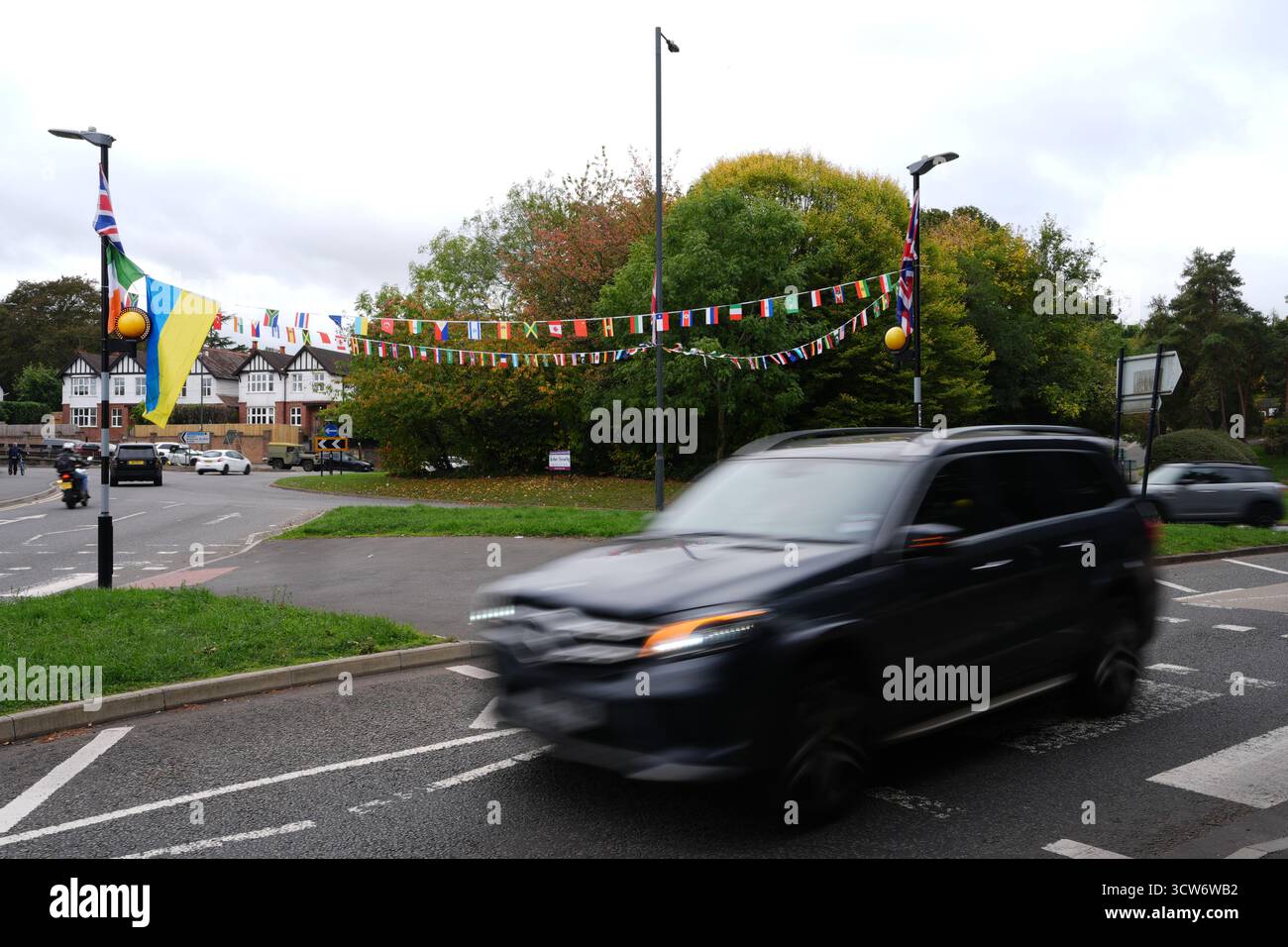 Bunting string of international flags which have been hung from posts ...