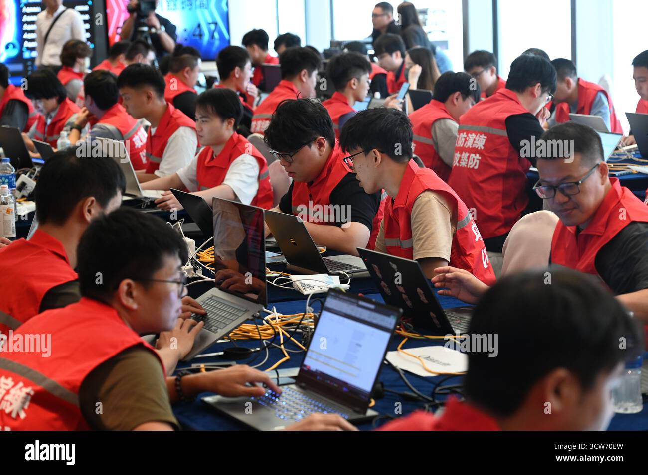 People participating in the cybersecurity exercise using computers ...