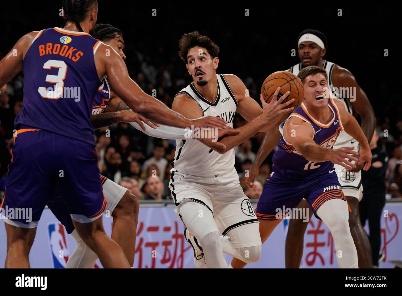 Phoenix Suns center Nick Richards fouls Brooklyn Nets guard Ben Saraf (77) during a preseason ...
