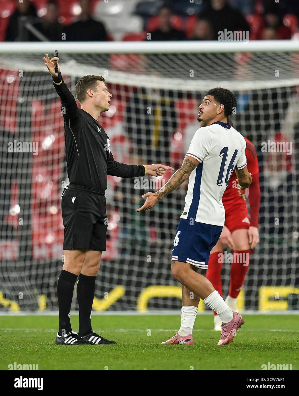 Urs Schnyder (Referee) having words with Morgan Gibbs-White of England ...