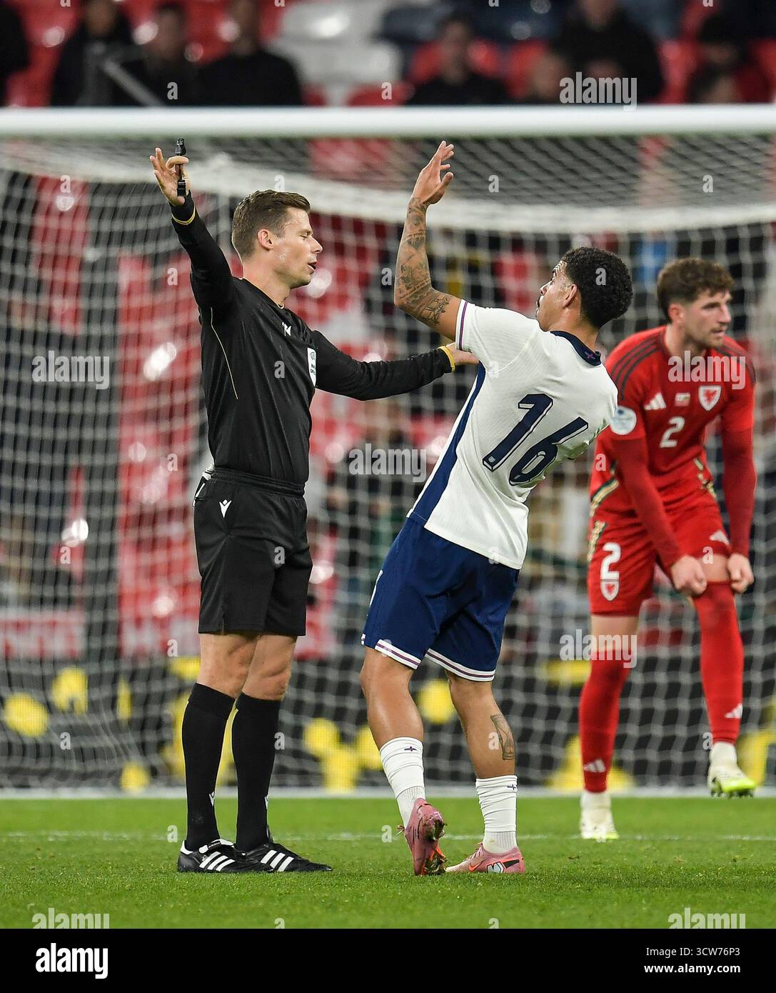 Urs Schnyder (Referee) having words with Morgan Gibbs-White of England ...