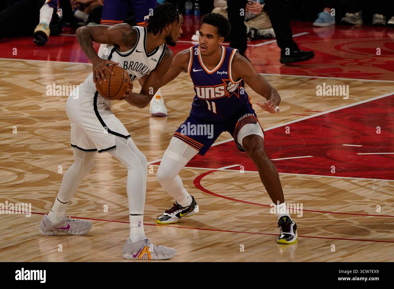 Phoenix Suns forward Oso Ighodaro (11) guards Brooklyn Nets center Nic ...