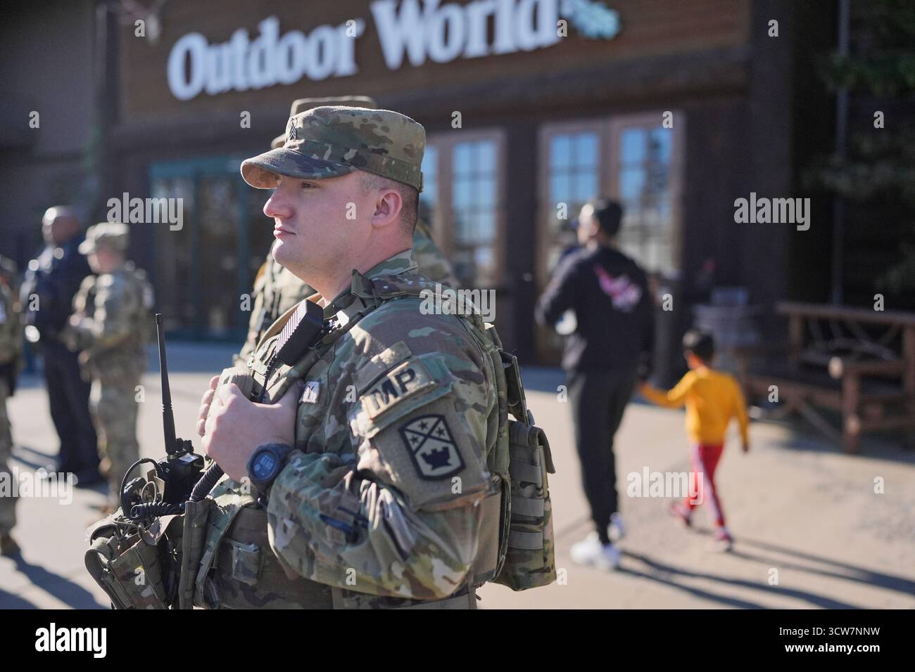 A member of National Guard stands outside a Bass Pro Shops while on ...