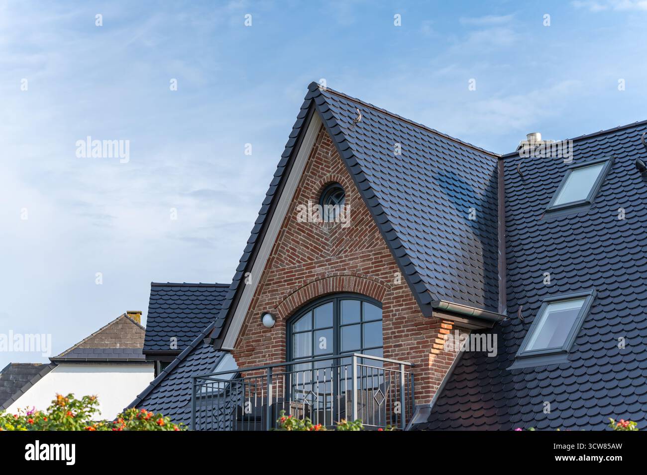 Modern brick house with slate roof. A modern brick house features a ...