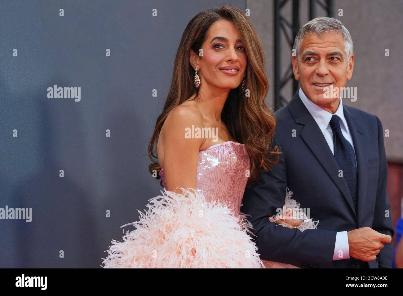 Amal Clooney, left, and George Clooney pose for photographers upon ...