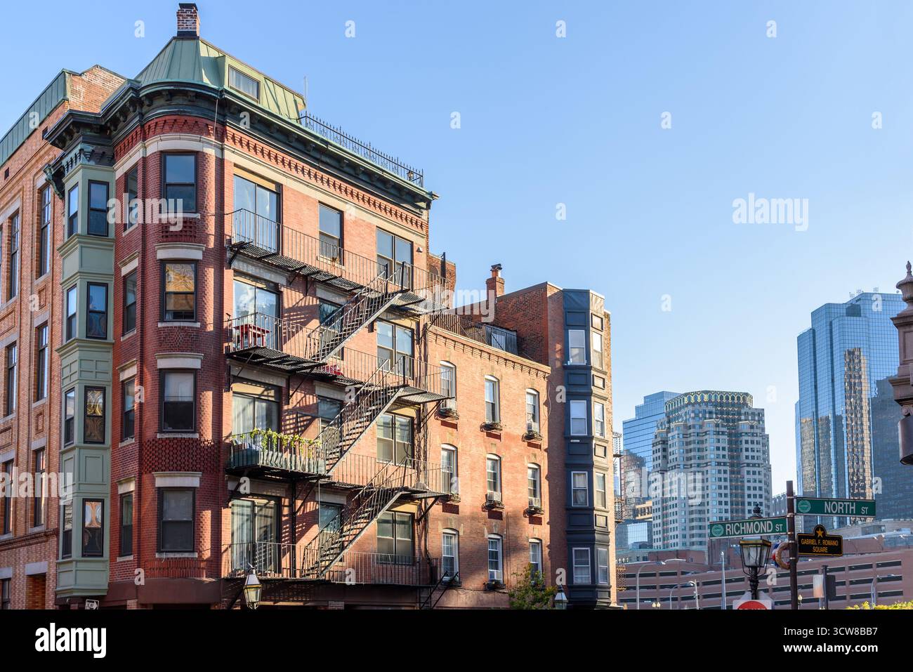 Traditional brick apartment building with metal fire escape in Boston ...