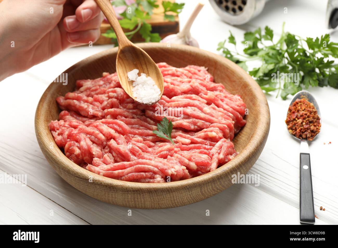 Woman adding salt raw minced hi-res stock photography and images - Alamy