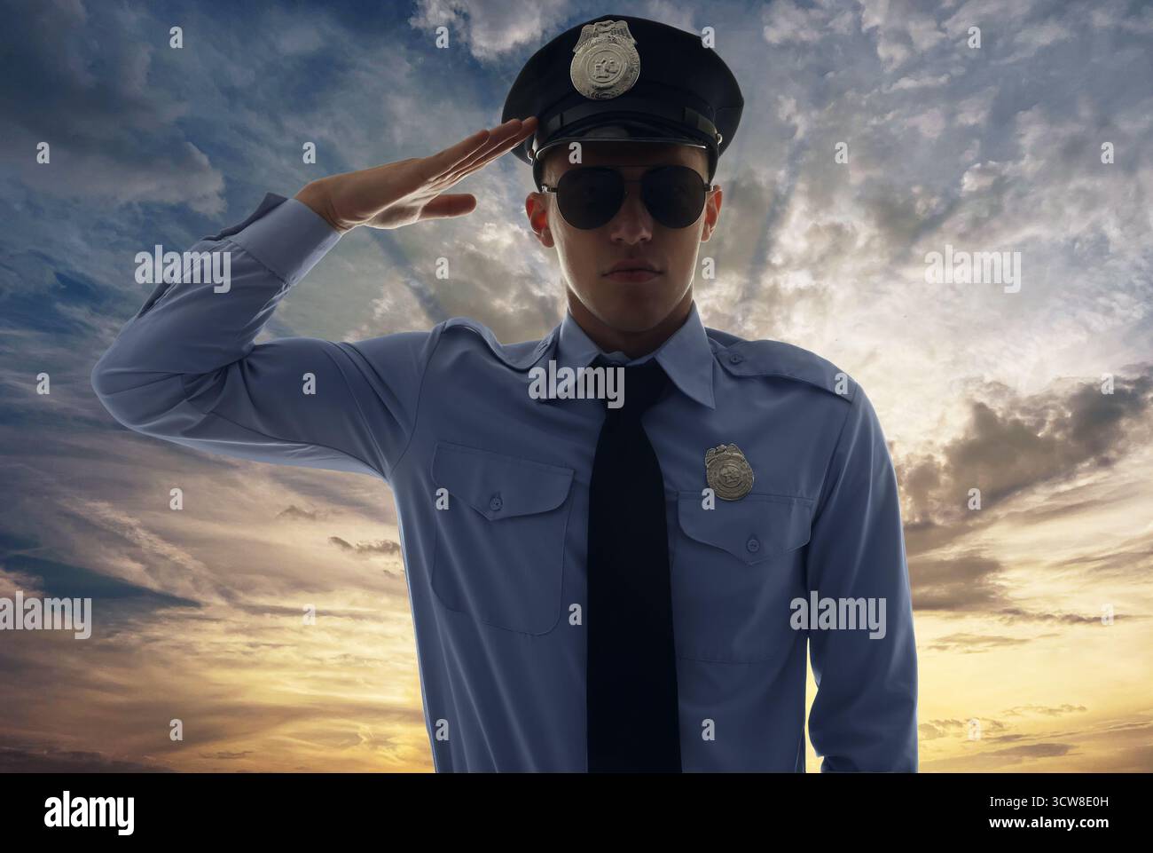 Police force. Man in uniform saluting against sky Stock Photo - Alamy