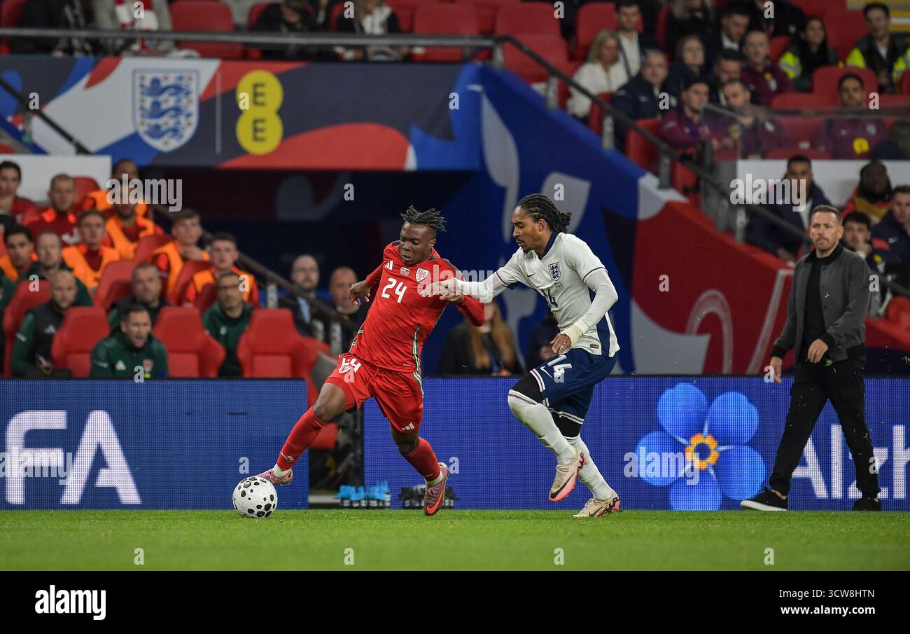 Djed Spence of England and Ronan Kpakio of Wales in action during the ...