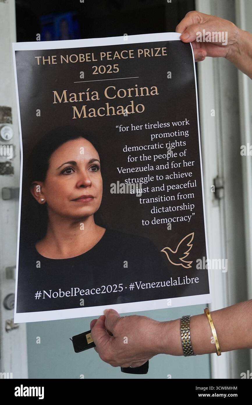 Iris Wilthew holds a poster in support of Venezuelan opposition leader ...