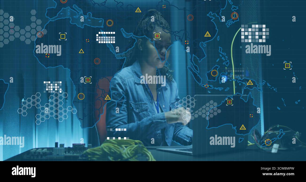 Monitoring engineer wearing denim shirt operating laptop at tech lab ...