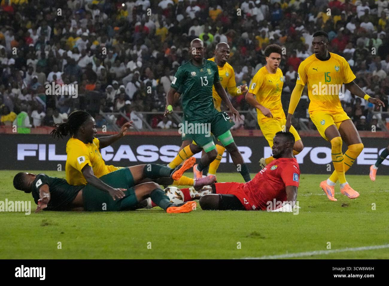 Zimbabwe's goalkeeper Washington Arubi, bottom right, saves during a ...