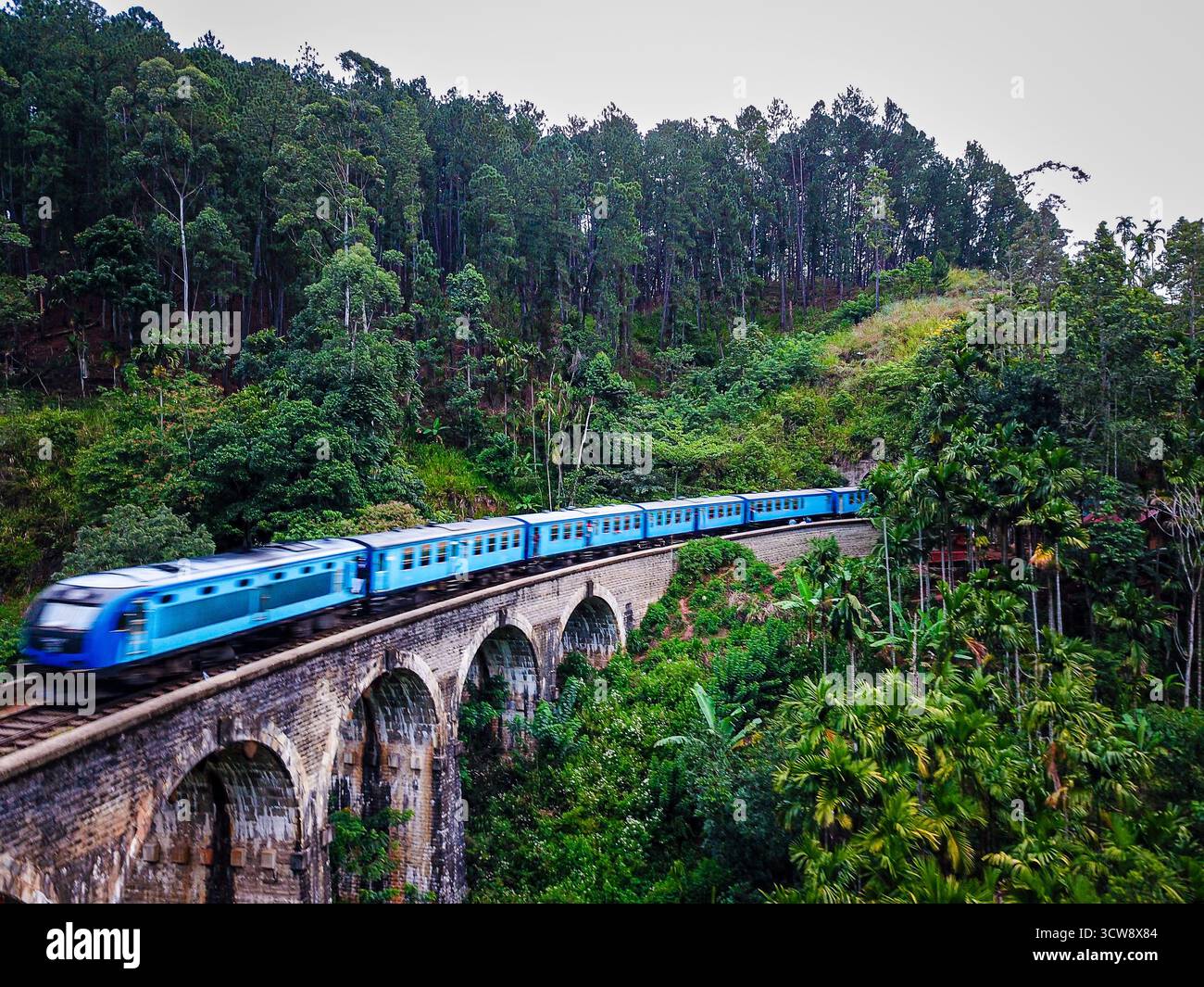 Blue passenger train crosses hi-res stock photography and images - Alamy