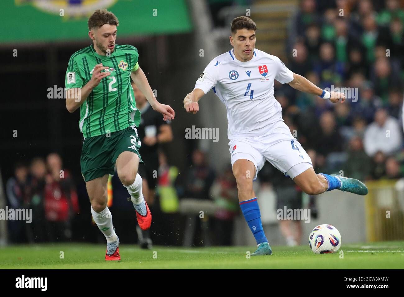 Ireland's Conor Bradley, left, challenges for the ball with Slovakia's ...