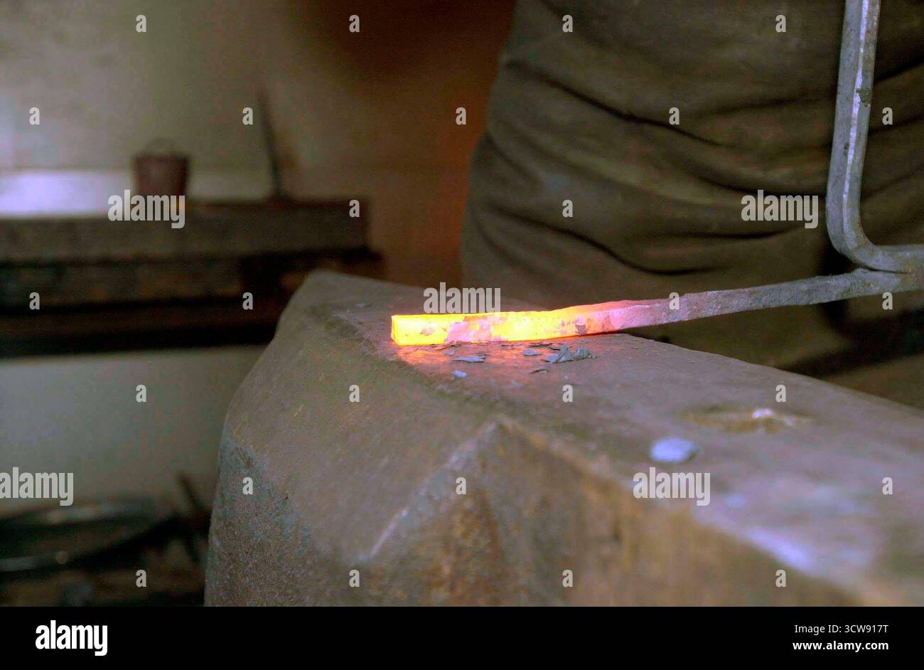 anvil and hammer in a forge, tools of a blacksmith anvil and hammer in ...