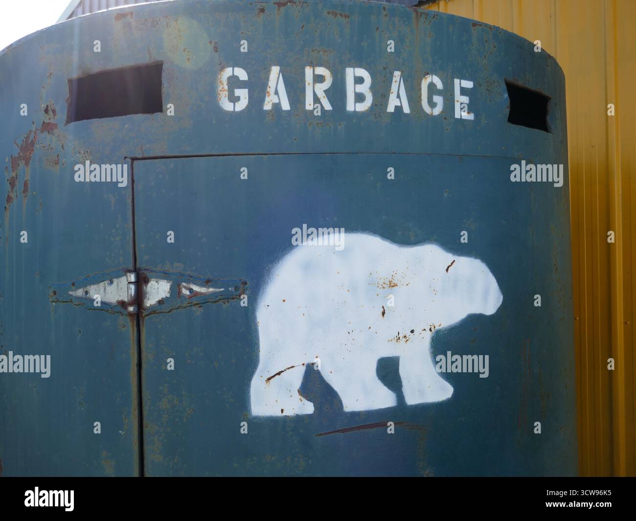 Polar bear protected metal garbage can Stock Photo - Alamy