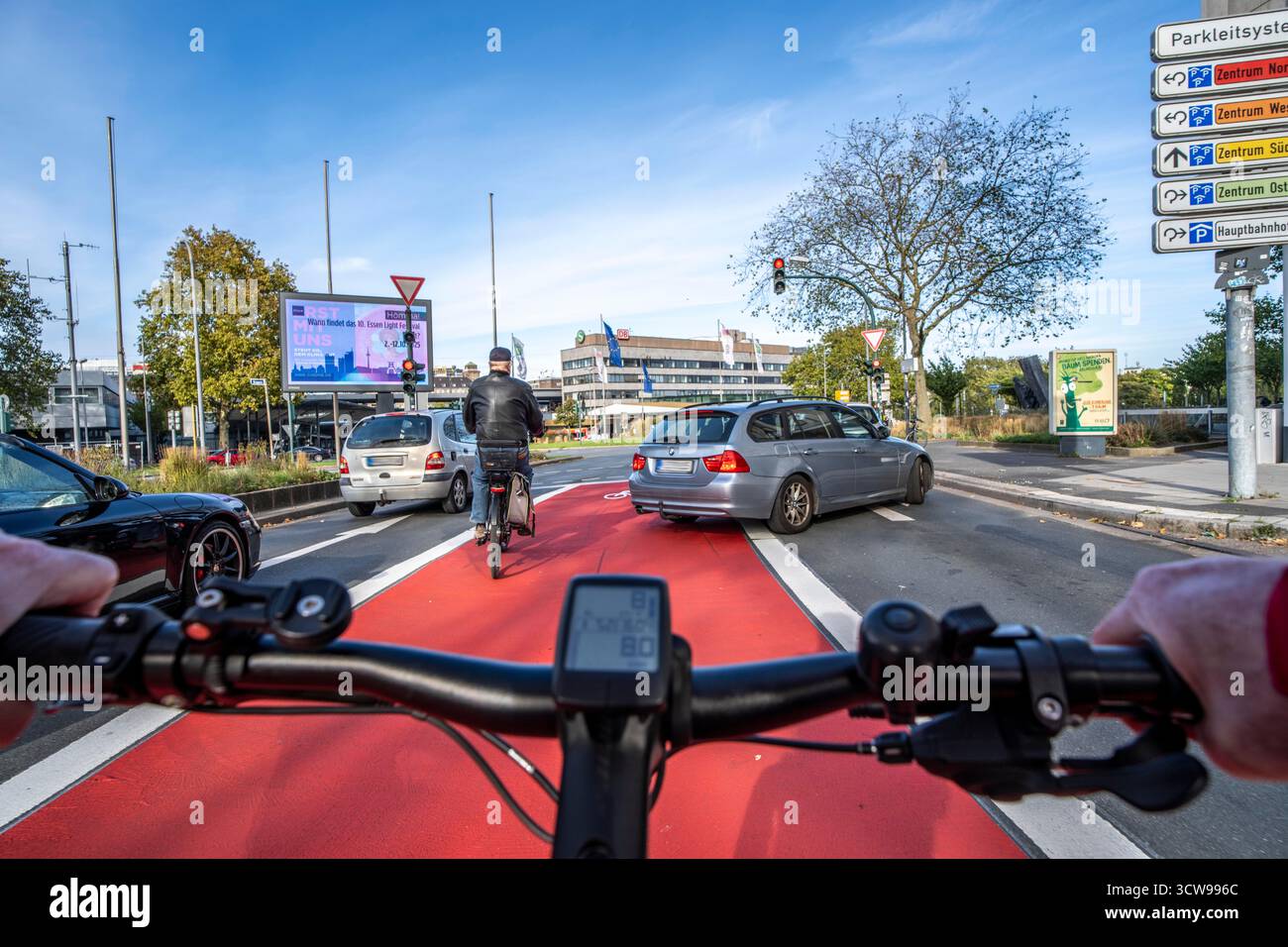 Riding a bike on a bike lane, marked in red to alert drivers to the ...