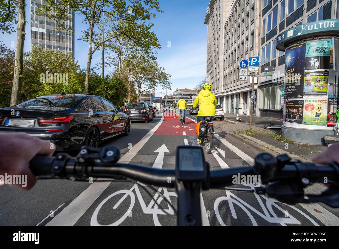 Riding a bike on a bike lane, marked in red to alert drivers to the ...