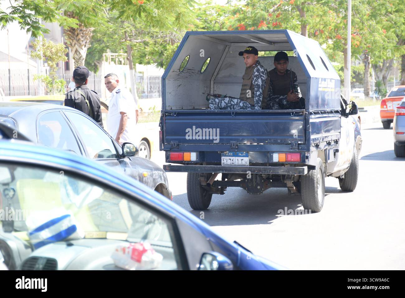 Ismailia, Egypt – Armed Egyptian police officers stand around a police ...