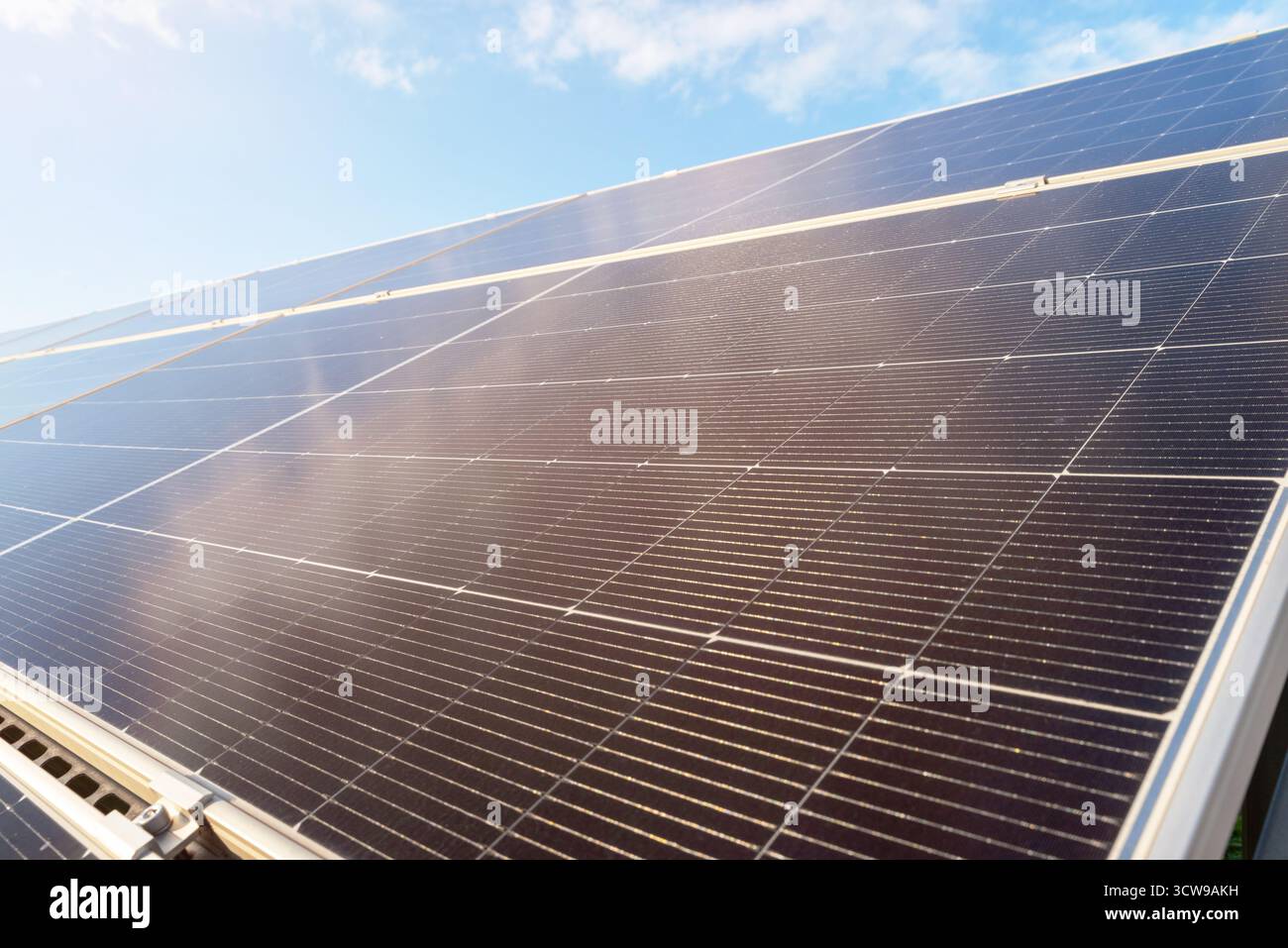 Close-up of photovoltaic solar panels producing renewable energy under ...