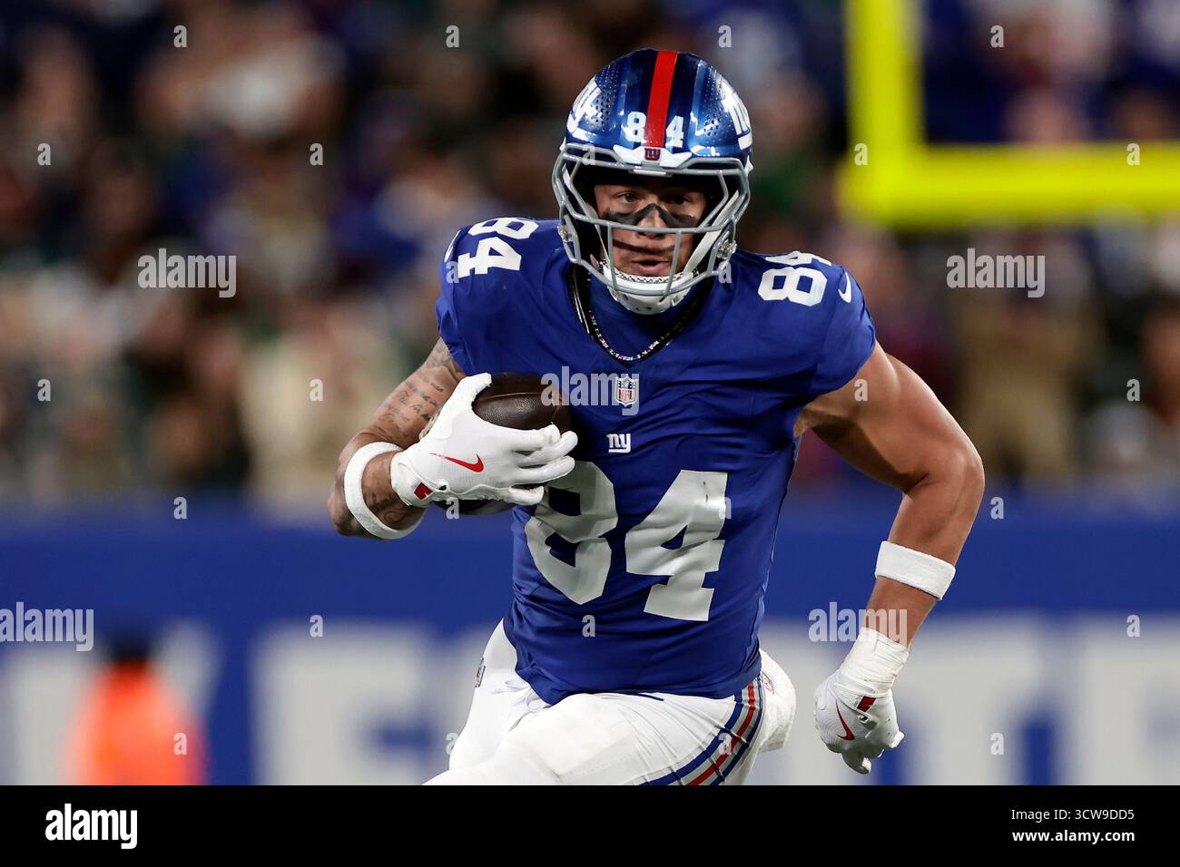 New York Giants tight end Theo Johnson (84) runs with the ball during the second half of an NFL ...