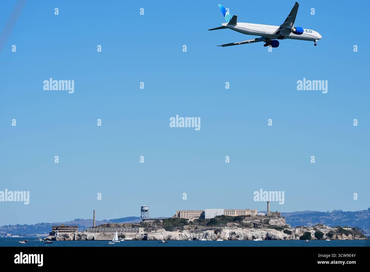 An United Airlines plane flies over Alcatraz Island during the San ...