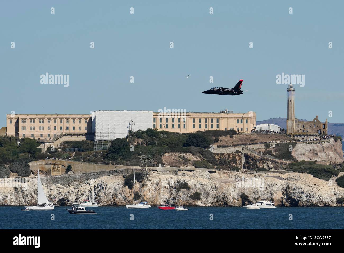 A member of the Patriots Jet Team flies over Alcatraz Island during the ...