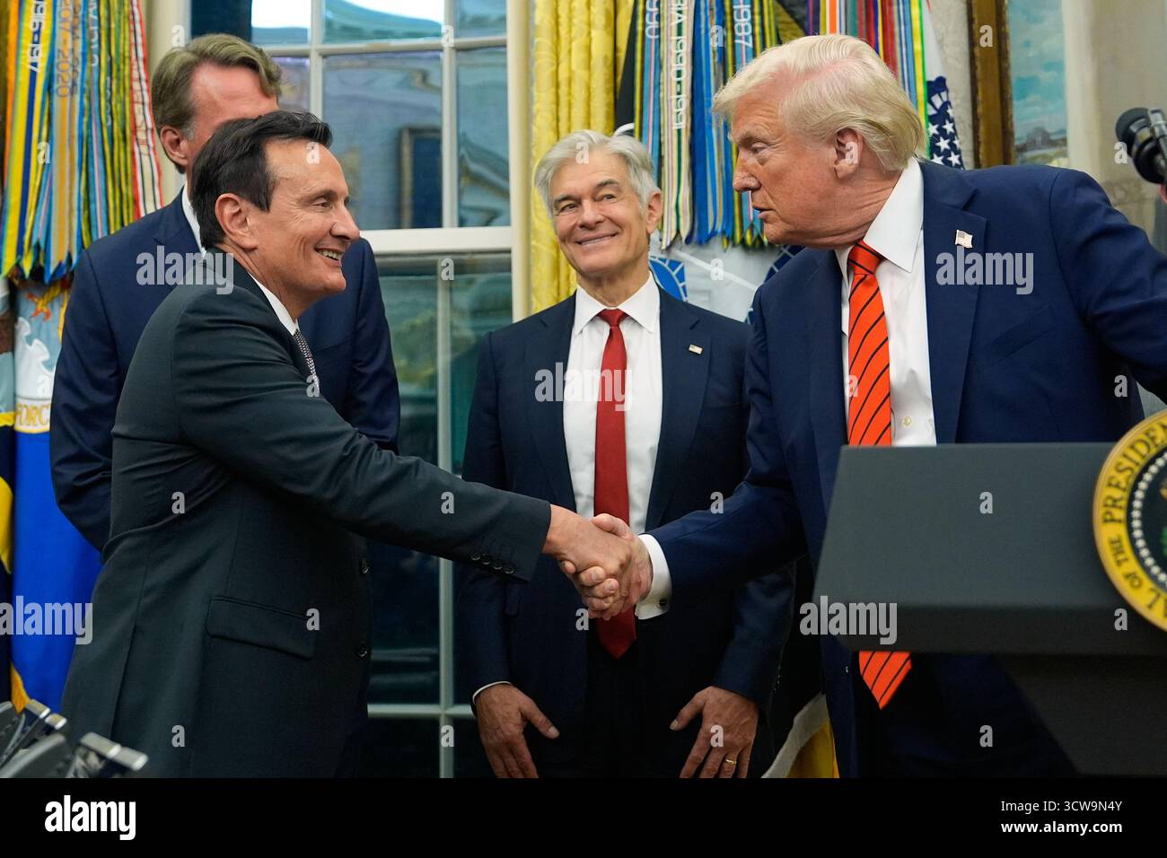 President Donald Trump shakes hands with AstraZeneca CEO Pascal Soriot ...