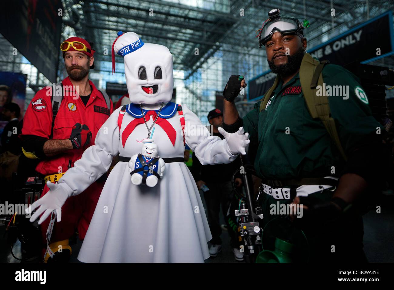Attendees dressed as characters from Ghostbusters pose during New York ...