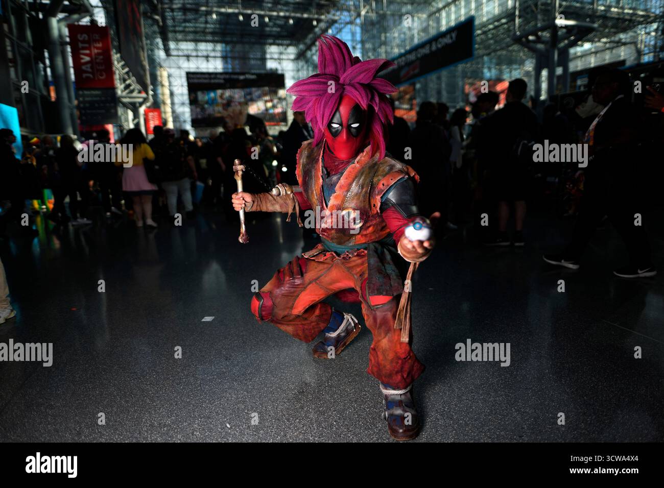An attendee dressed as a mashup of Dragon Ball Z and Deadpool poses ...
