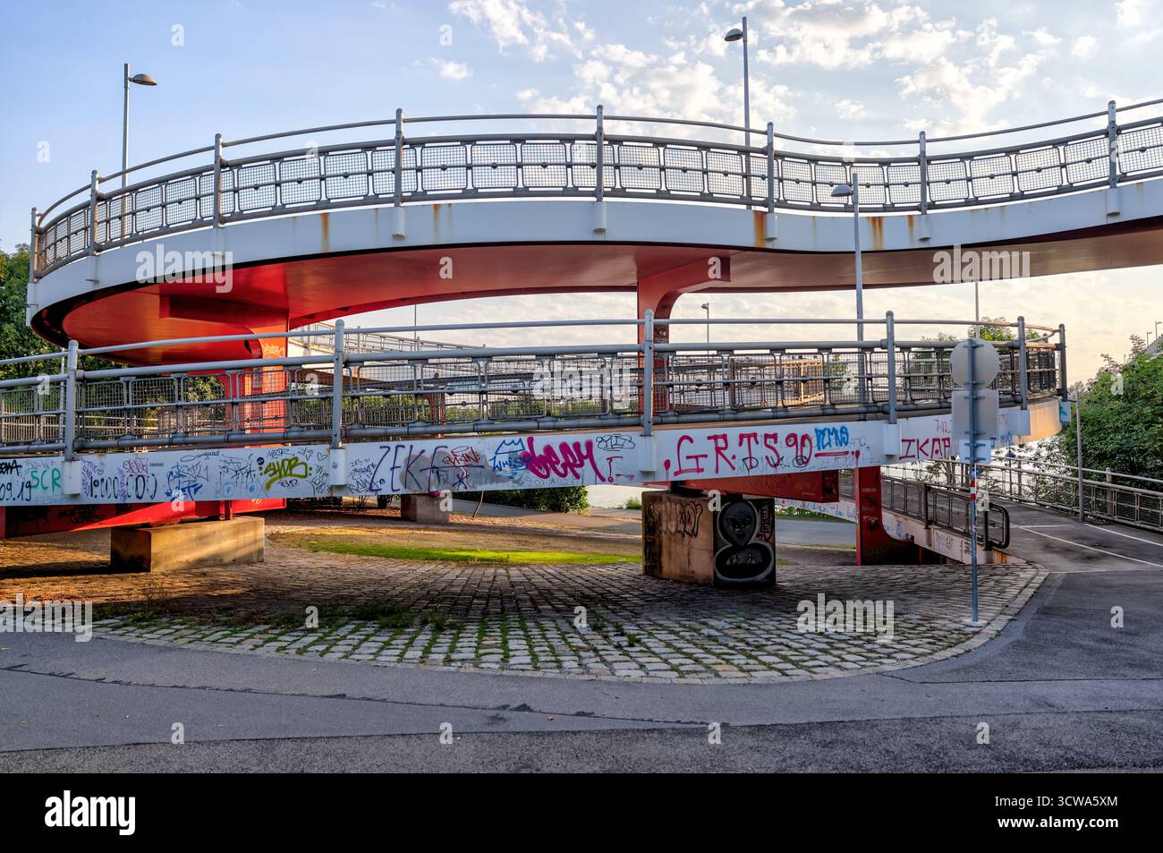 Circular pedestrian ramp and overpass covered in graffiti near the ...