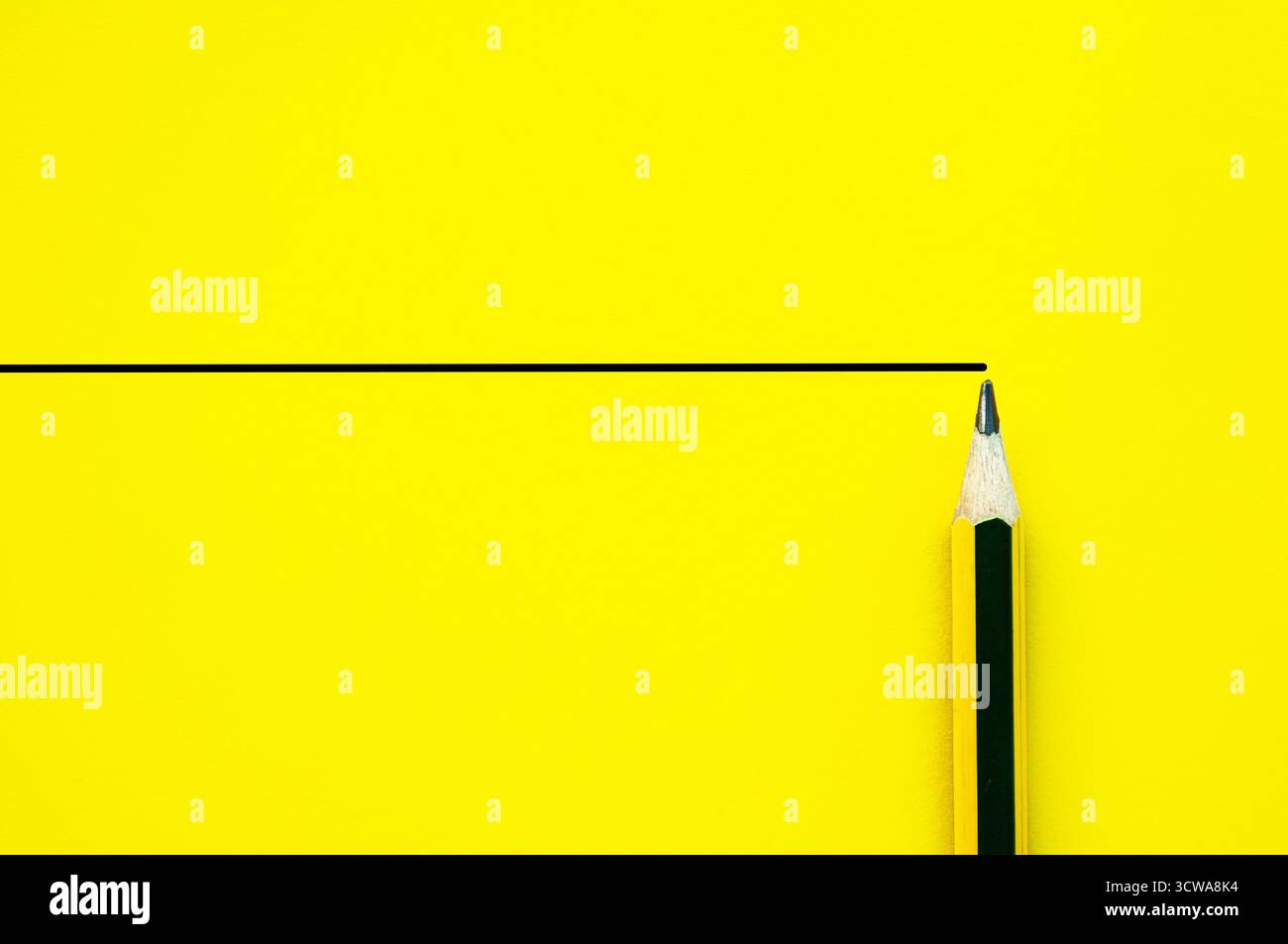 Bright yellow sheet with horizontal rule and sharpened pencil corner ...