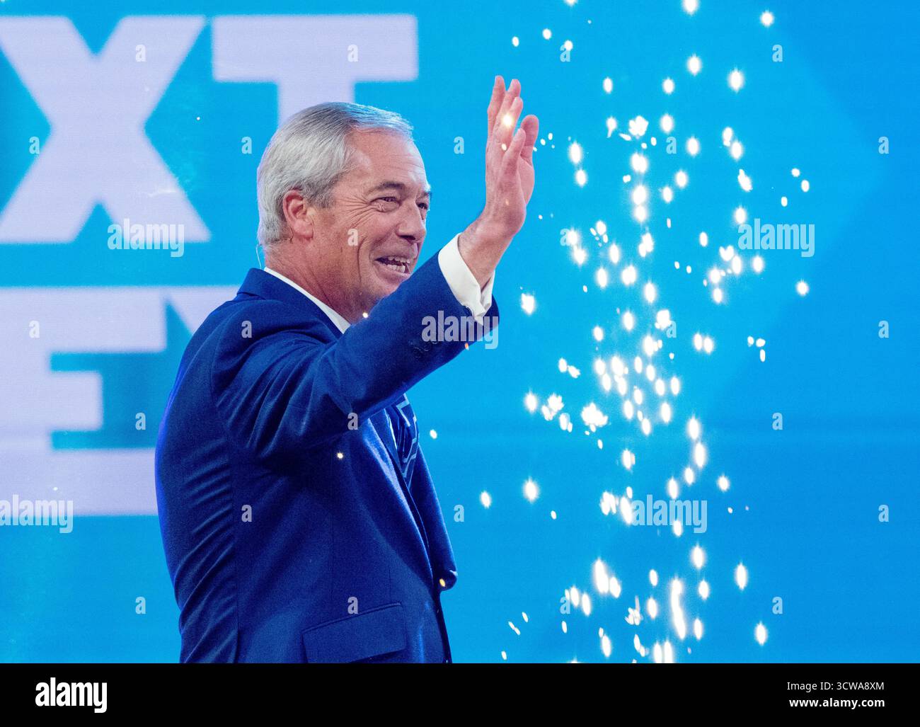 Reform UK Party Leader Nigel Farage arrives on stage with fireworks at ...